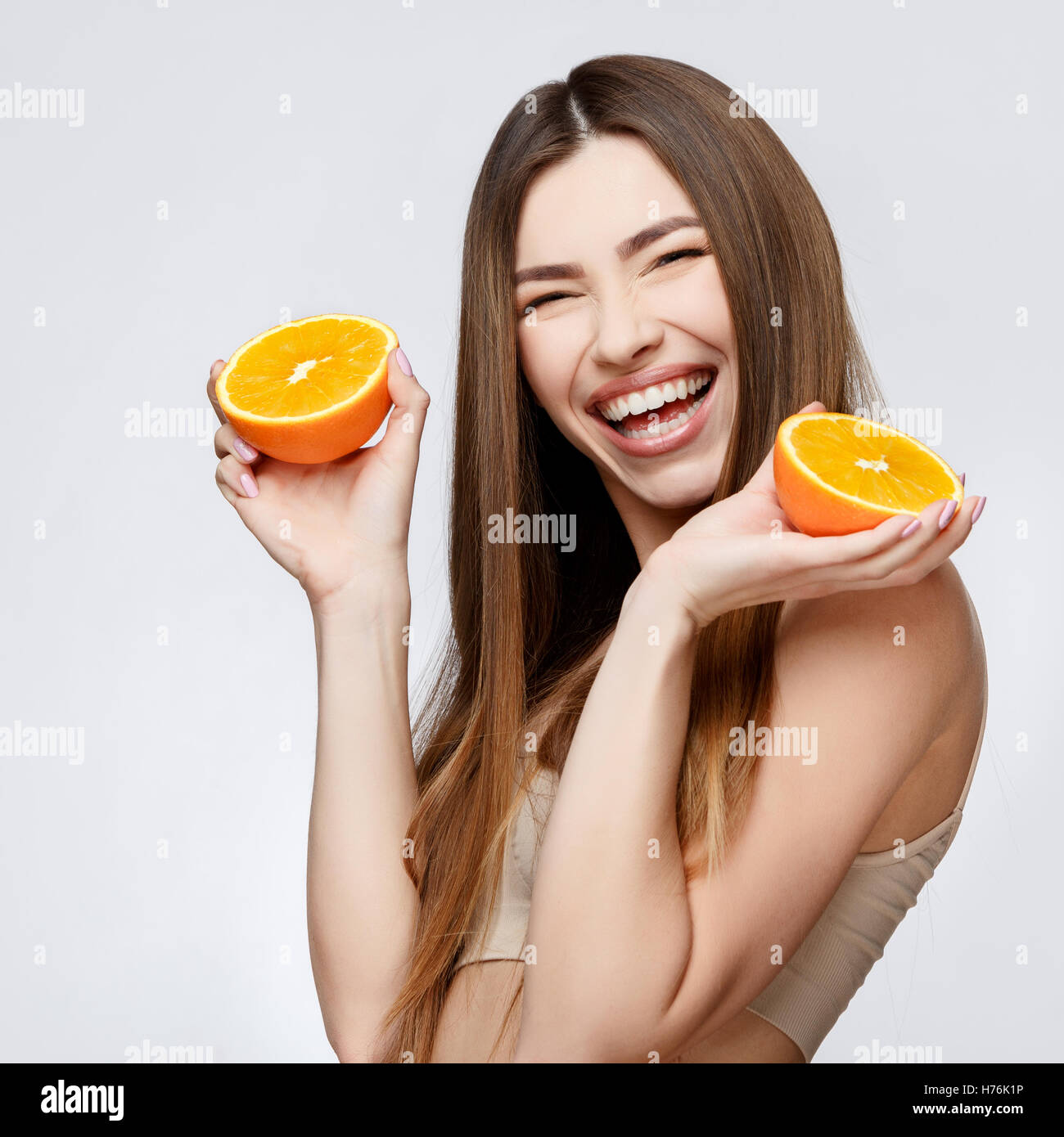 Beautiful Woman with Clean Fresh Skin holding orange Stock Photo - Alamy