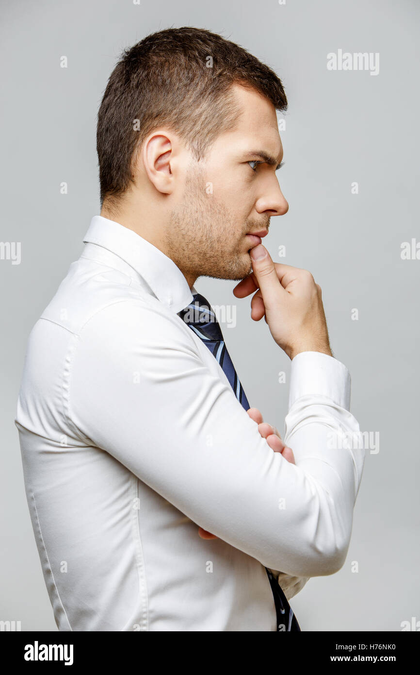 Handsome businessman on grey hi-res stock photography and images - Alamy