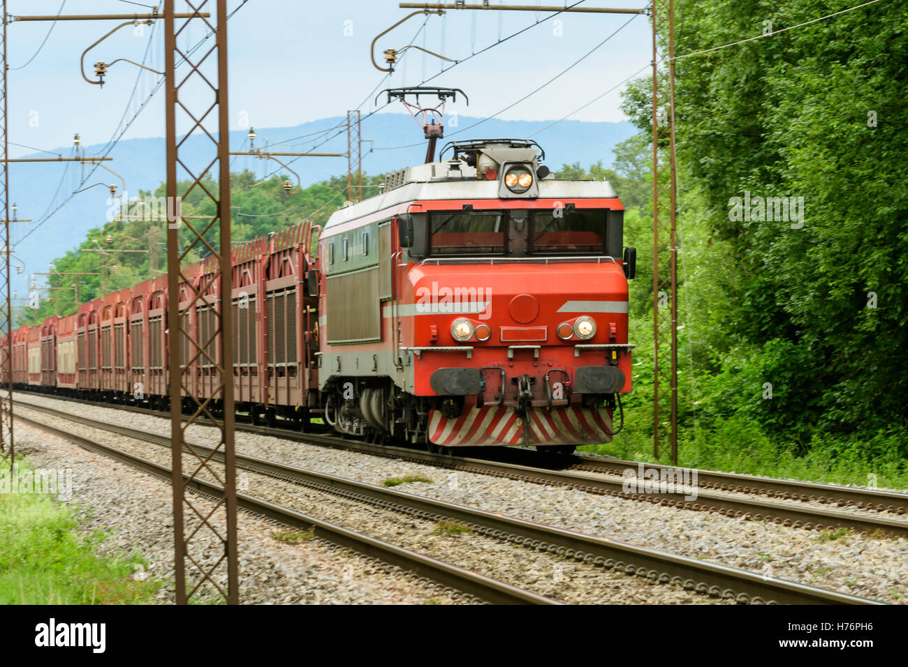 Red locomotive towing a freight train Stock Photo - Alamy