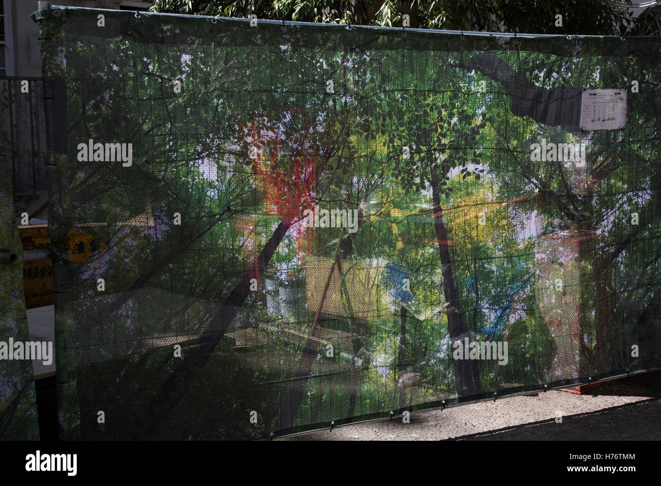 Tree print pattern hoarding designed to look natural in covering up a ...