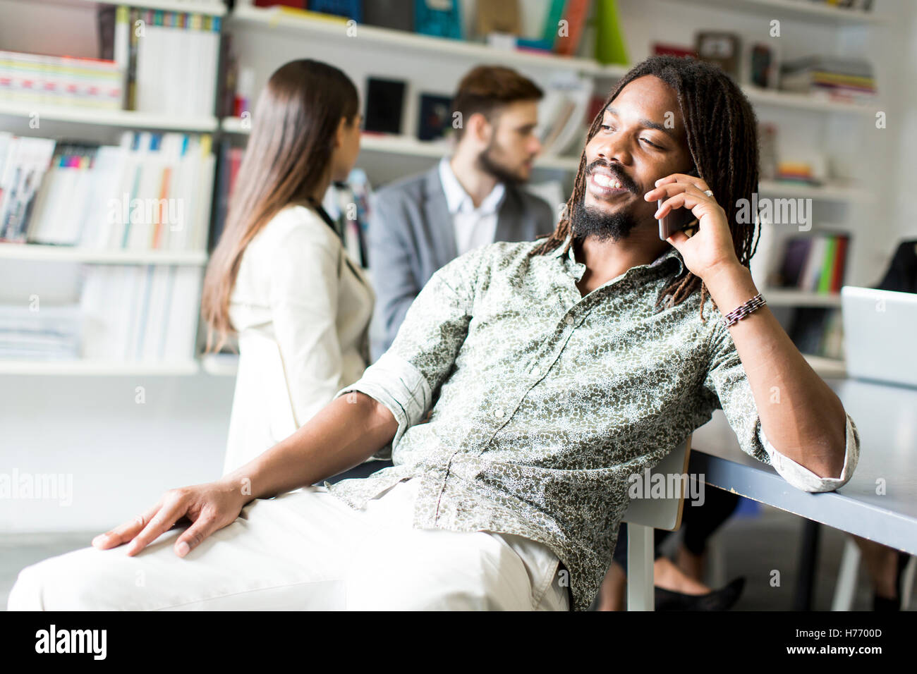 Young african american man talking over the phone in office Stock Photo ...