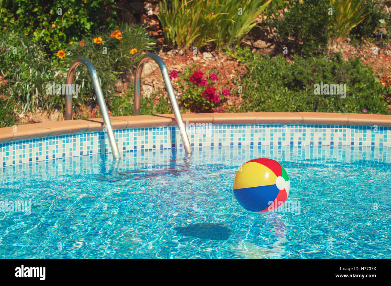 Beach ball floating in summer swimming pool with vintage feel Stock ...