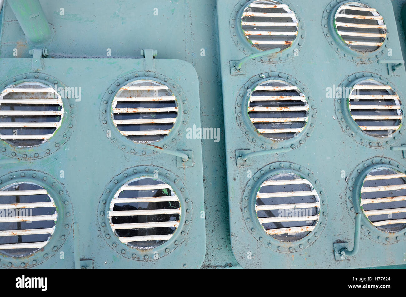 Old metallic window shutters mounted on a floor of ship, boat or yacht ...