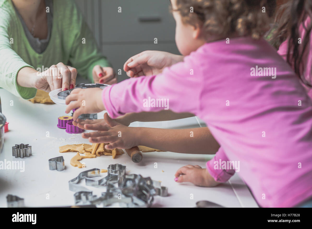 Mother and two girls baking christmas cookies Stock Photo - Alamy