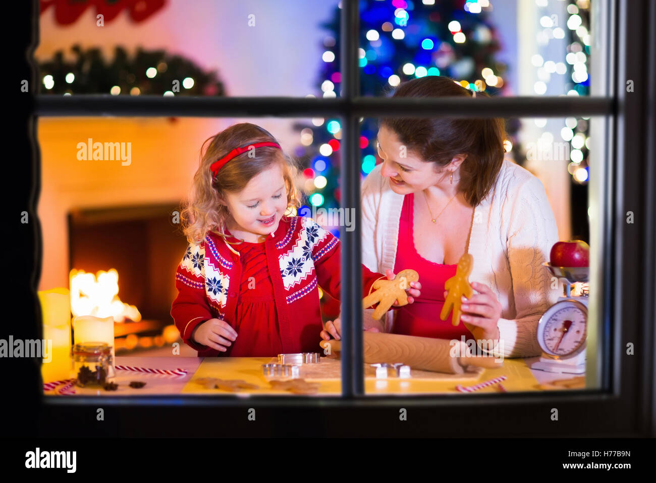 Mother and little girl baking Christmas pastry. Children bake ...