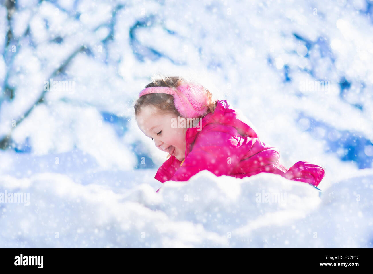 Child running in snowy forest. Toddler kid playing outdoors. Kids play ...