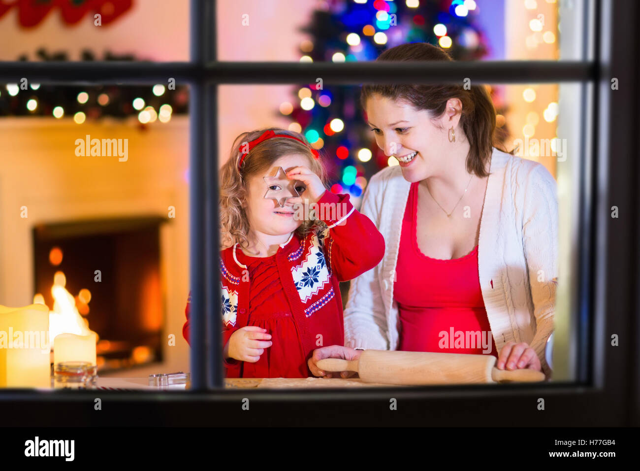 Mother and little girl baking Christmas pastry. Children bake ...