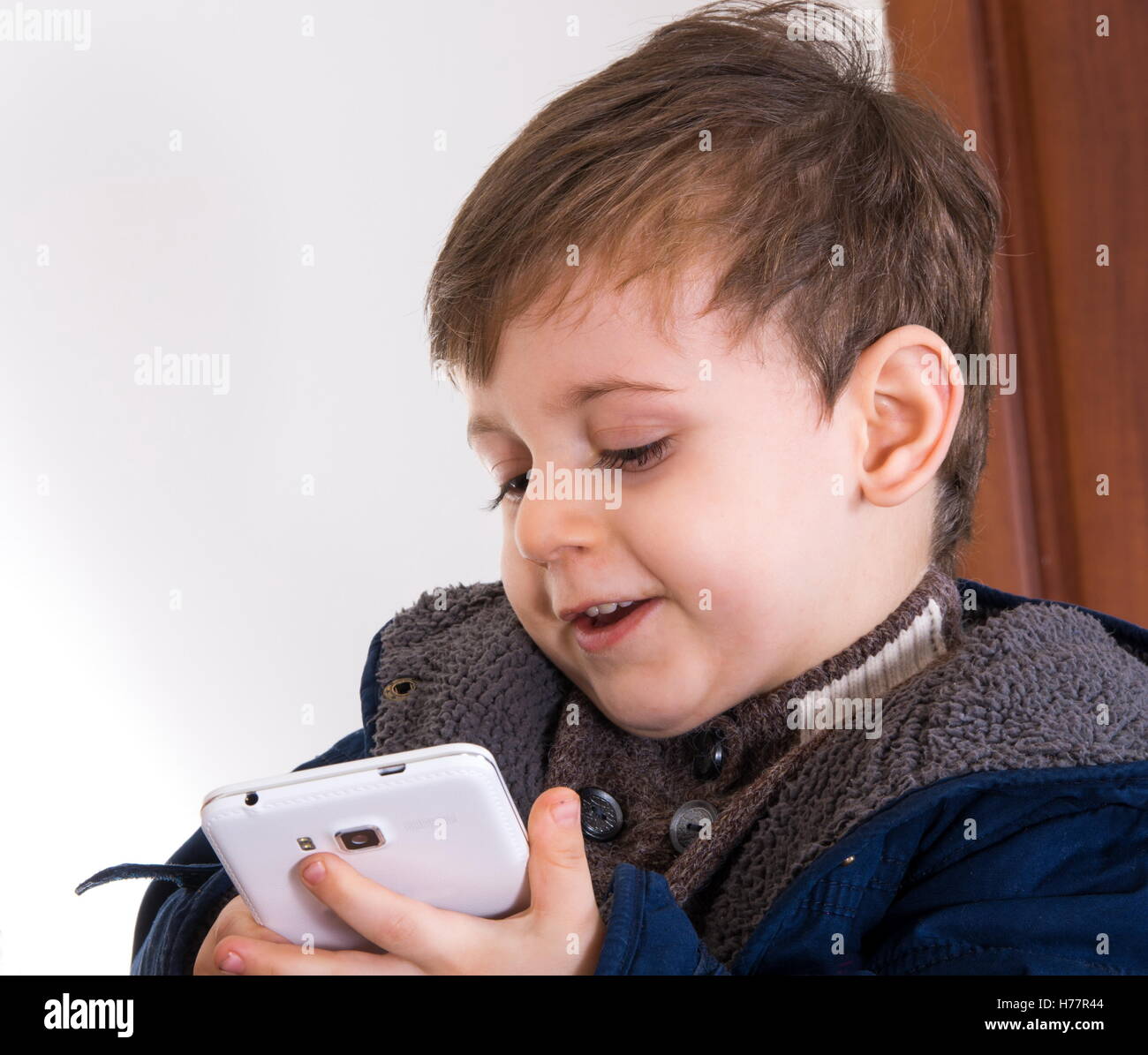 cute boy portrait on white whith phone Stock Photo - Alamy
