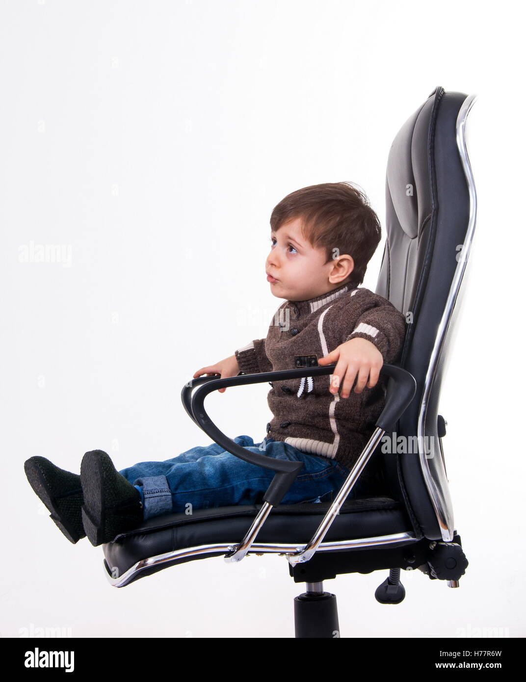little boy sitting on chair Stock Photo - Alamy