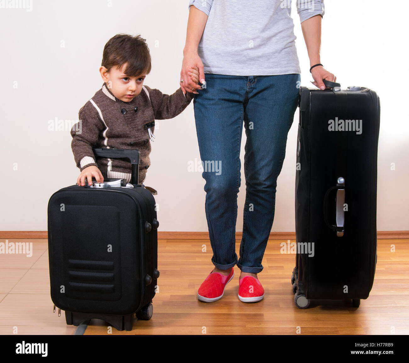 child with mother packing bags for holiday Stock Photo - Alamy