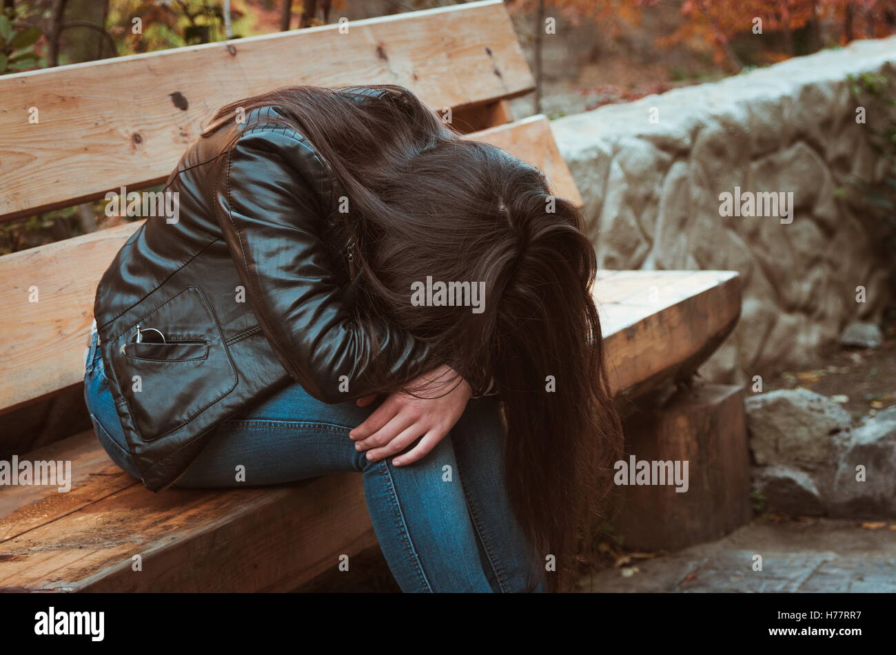 depressed girl sitting on bench in the park Stock Photo - Alamy
