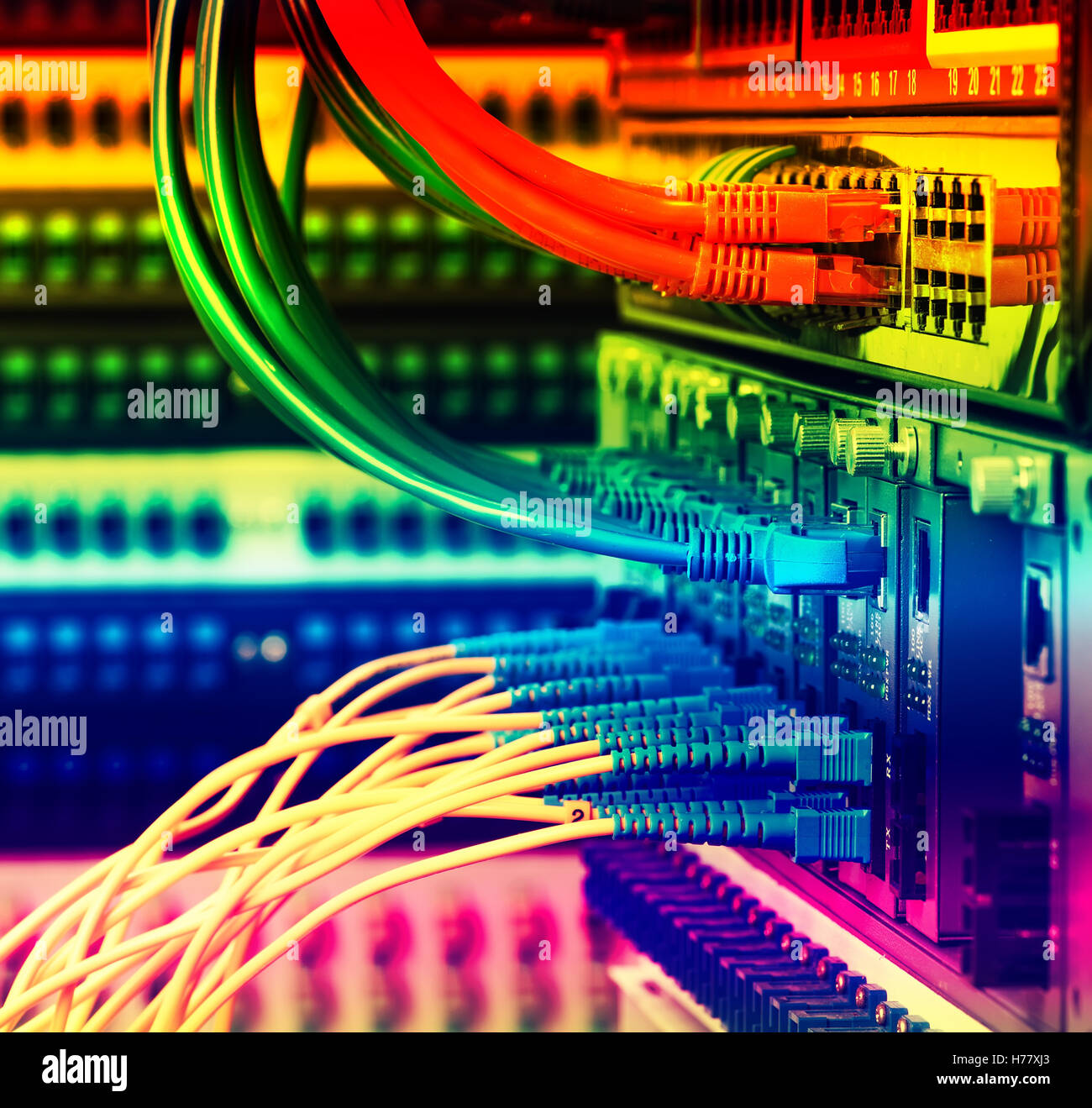 Fiber Optic cables connected to an optic ports and Network cables ...