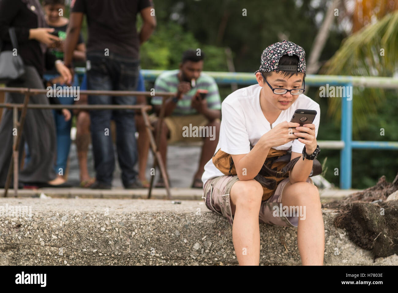 a guy playing with his phone Stock Photo - Alamy