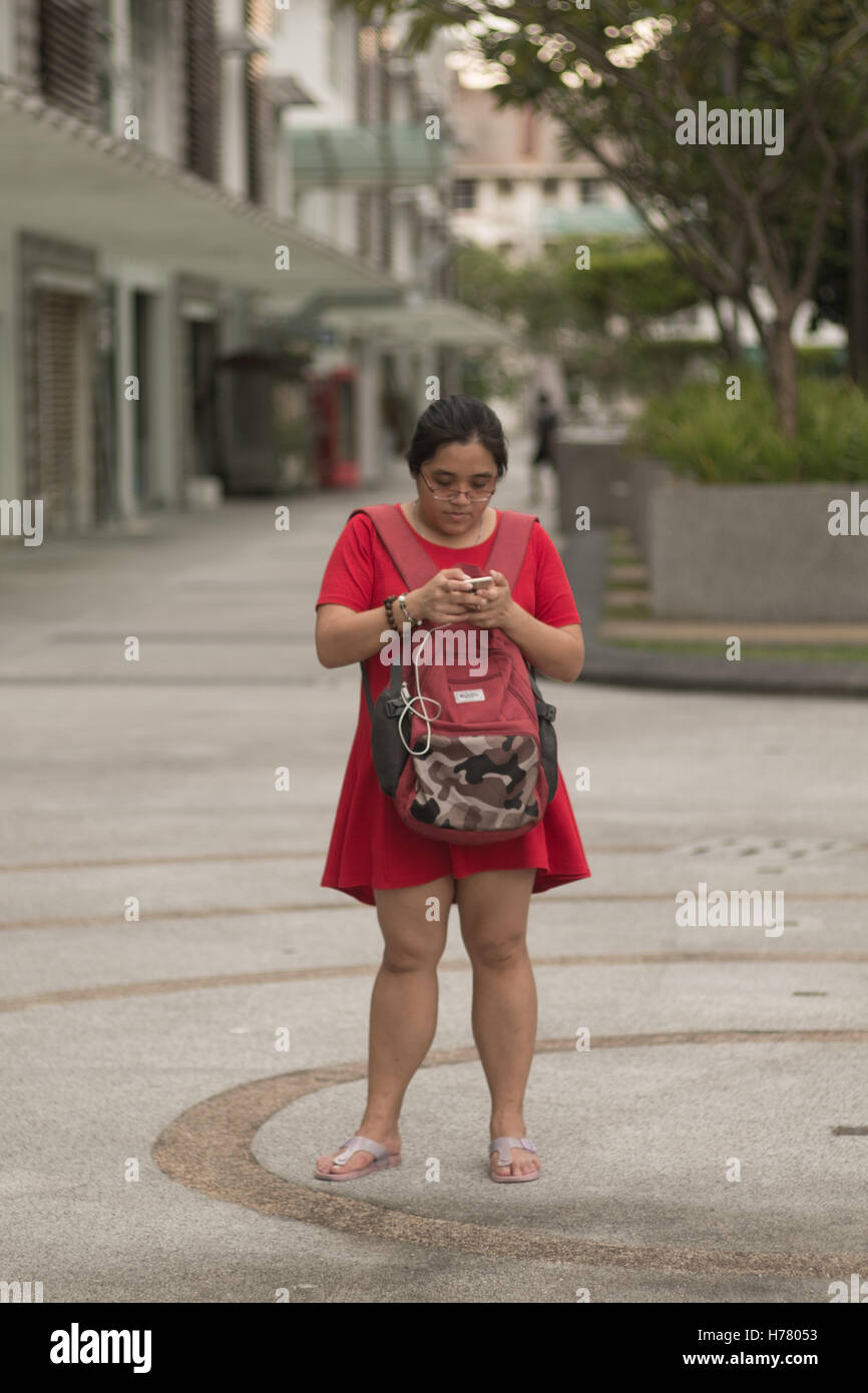 a girl using her phone hunting pokemon in pokemon go Stock Photo - Alamy