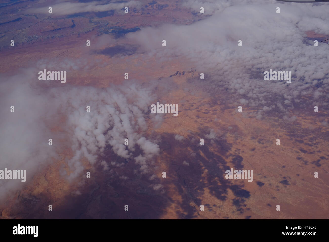 Clouds hovering over a dry desert landscape Stock Photo - Alamy