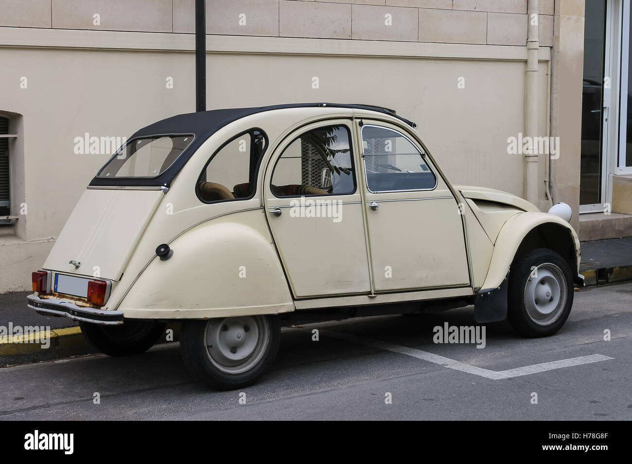 Small french retro car on a city street Stock Photo - Alamy