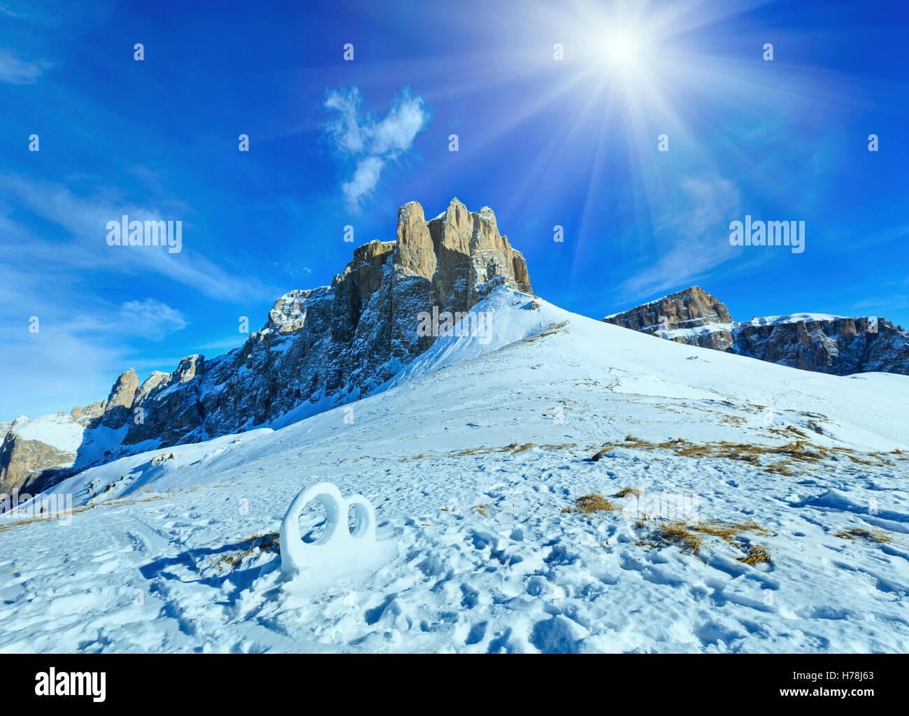Wedding ring sculpture from the snow on winter mountain sunshiny slope ...