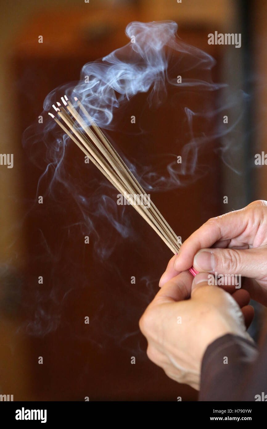 Lady praying with incense hi-res stock photography and images - Alamy