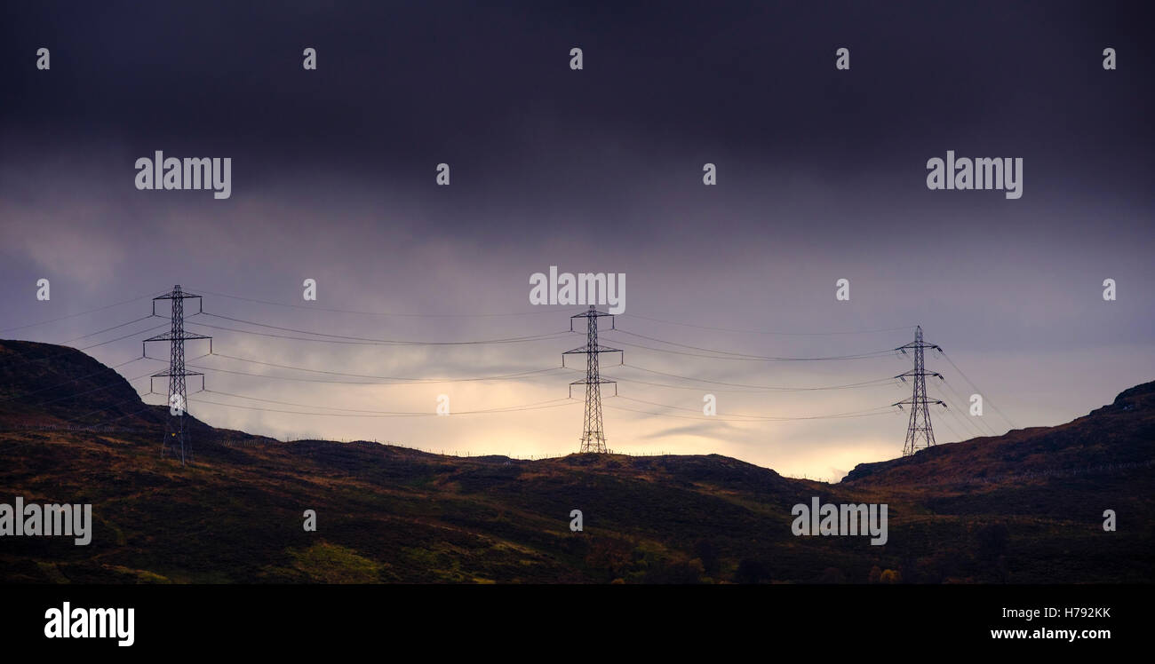 Electricity pylons cross the mountains high above Loch Arklet, Loch ...