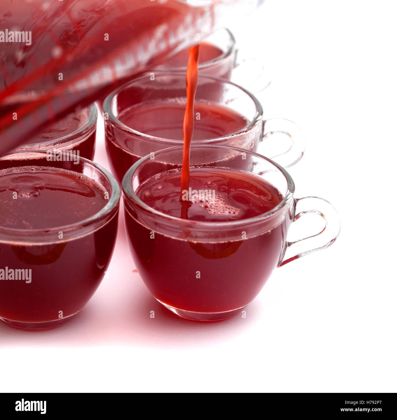 making individual strawberry jelly portions - pouring hot jelly mixture ...