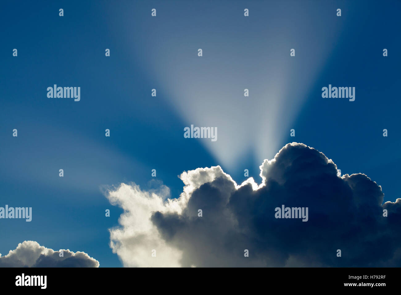 sun behind cumulus clouds natural skyscape background Stock Photo - Alamy