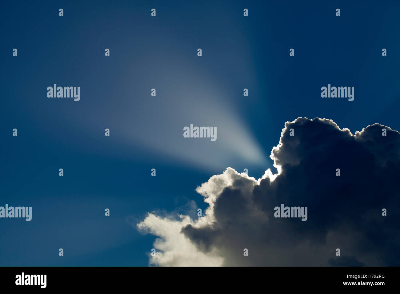 sun behind cumulus clouds natural skyscape background Stock Photo - Alamy