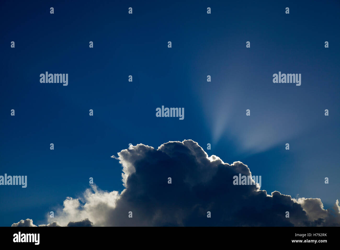 sun behind cumulus clouds natural skyscape background Stock Photo - Alamy