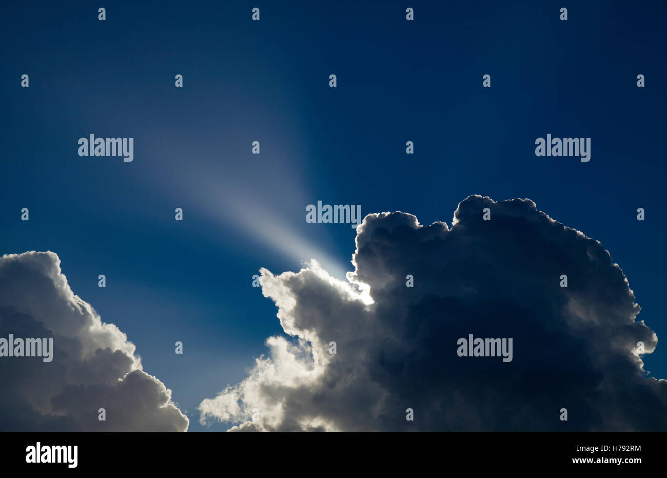 sun behind cumulus clouds natural skyscape background Stock Photo - Alamy