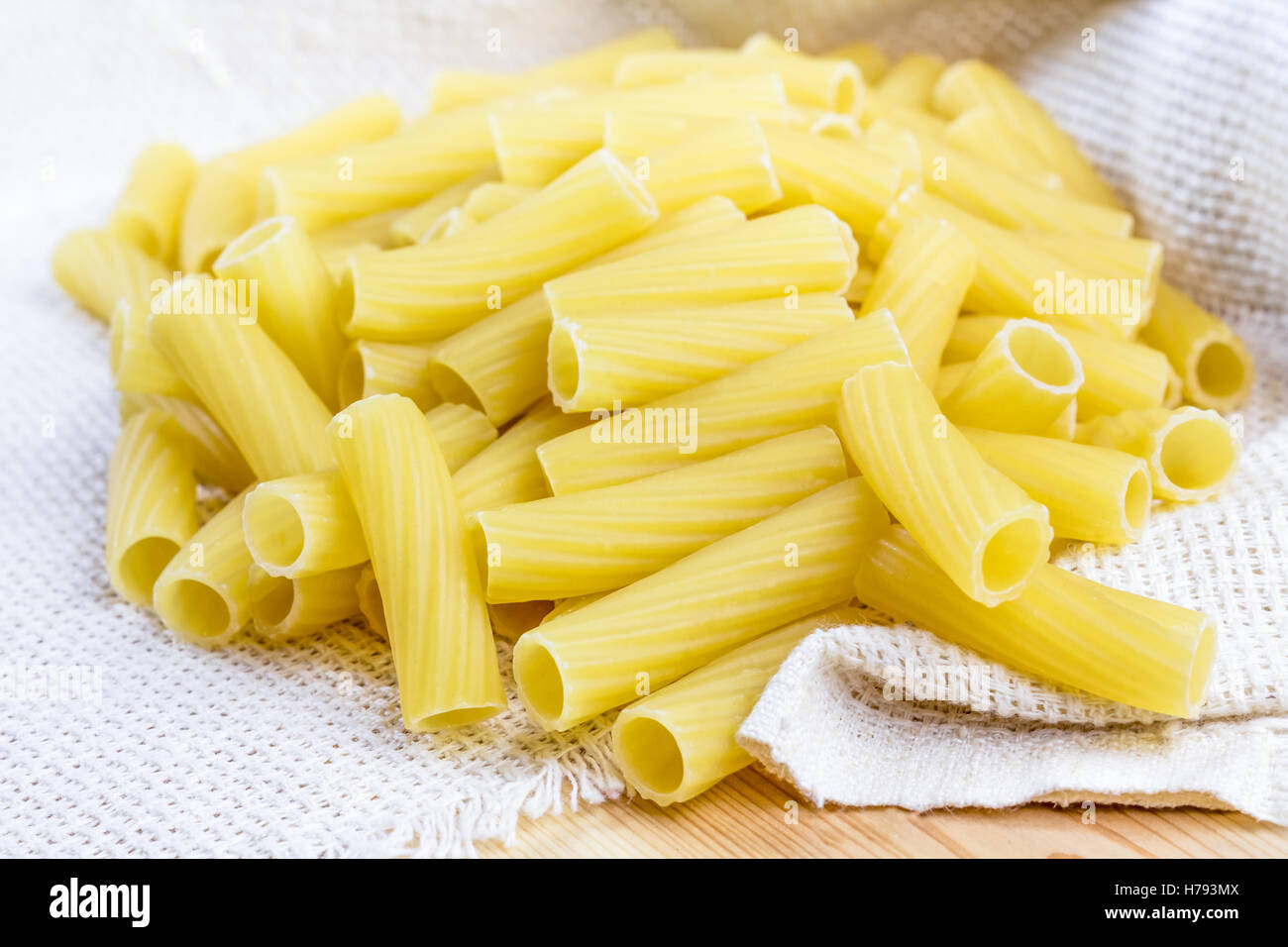 Raw uncooked tortiglioni pasta on canvas napkin Stock Photo - Alamy
