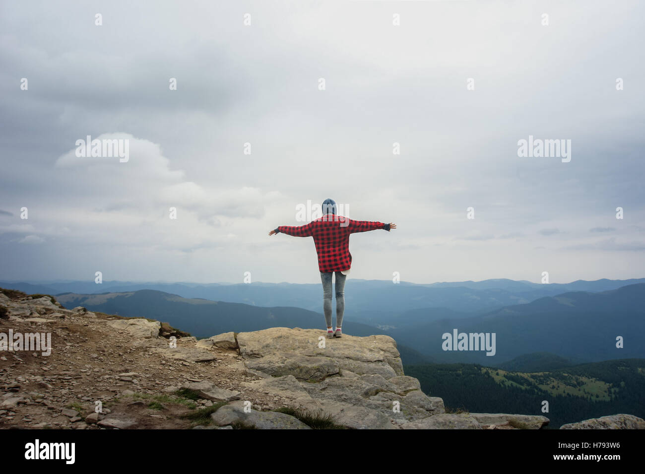 Girl Standing On Top Of A Mountain