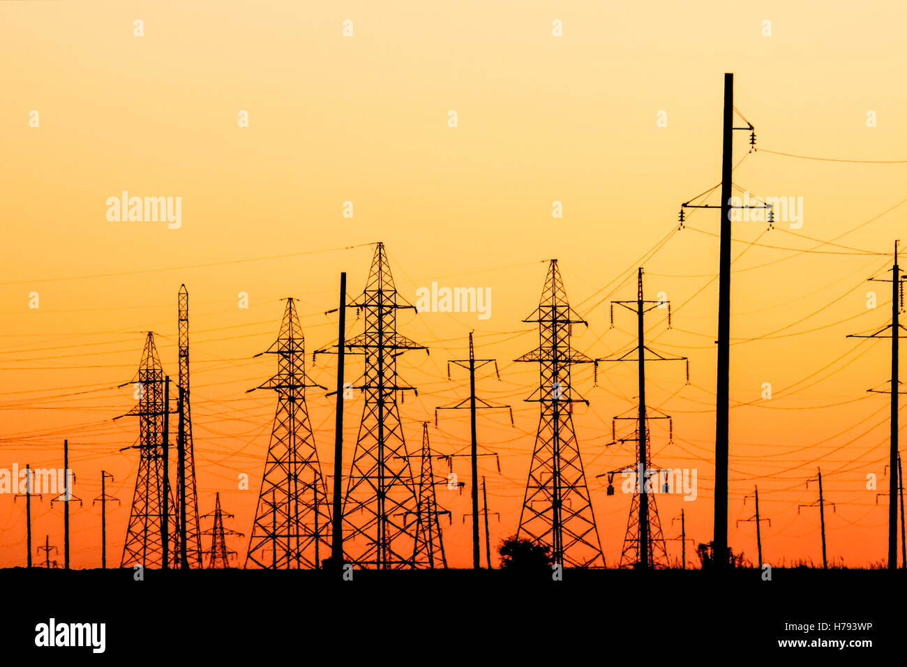 Power lines pylons at bright red orange sunset Stock Photo - Alamy