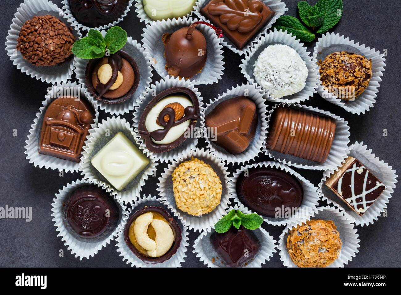 Fine chocolates assortment on gray background, top view Stock Photo - Alamy