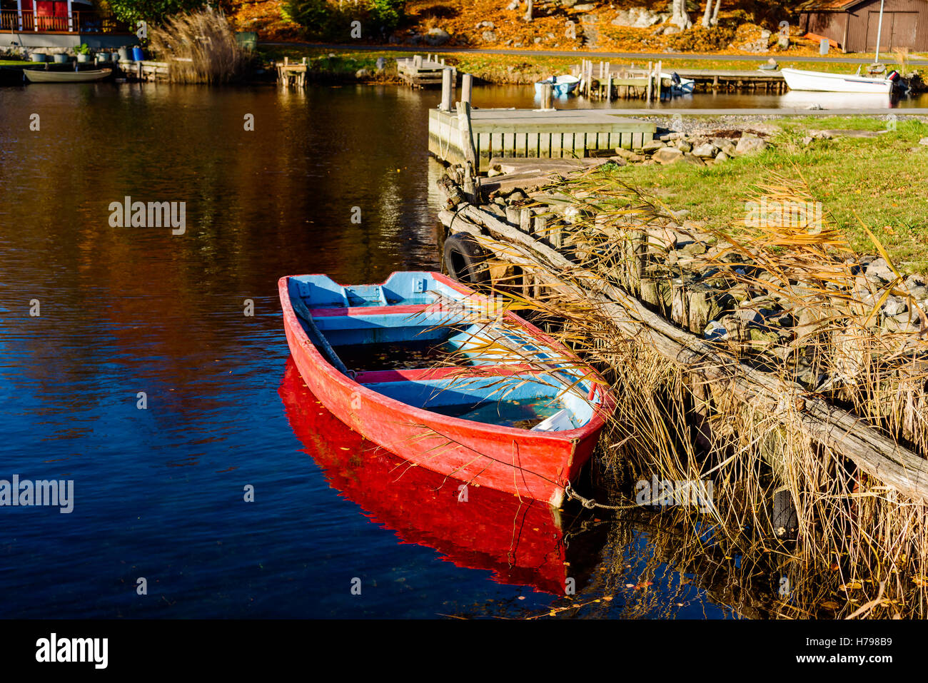 Small red rowboat in coastal landscape in fall. Bokevik outside Ronneby ...