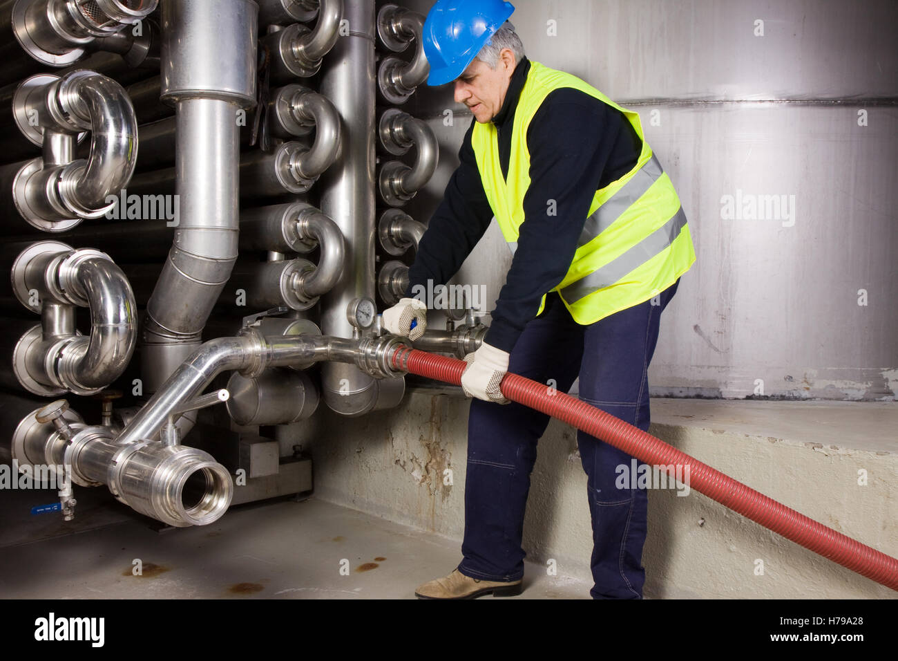 skilled worker fitting a pump in a industrial company Stock Photo - Alamy