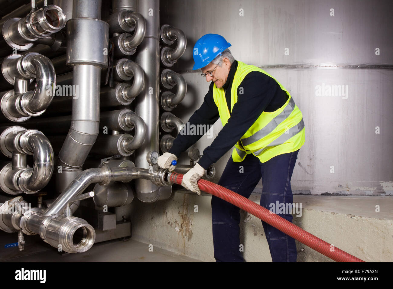 skilled worker fitting a pump in a industrial company Stock Photo - Alamy