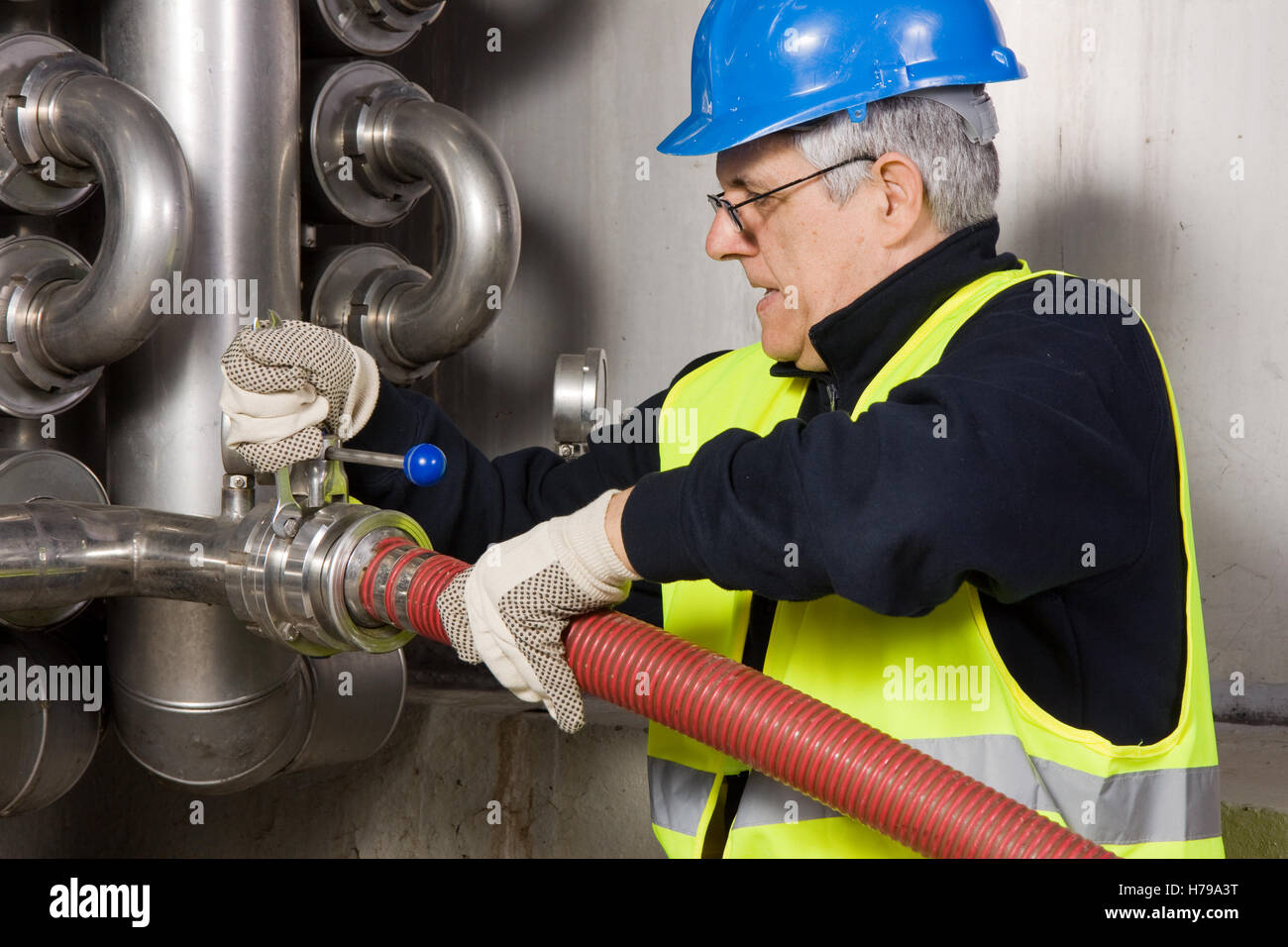 skilled worker fitting a pump in a industrial company Stock Photo - Alamy