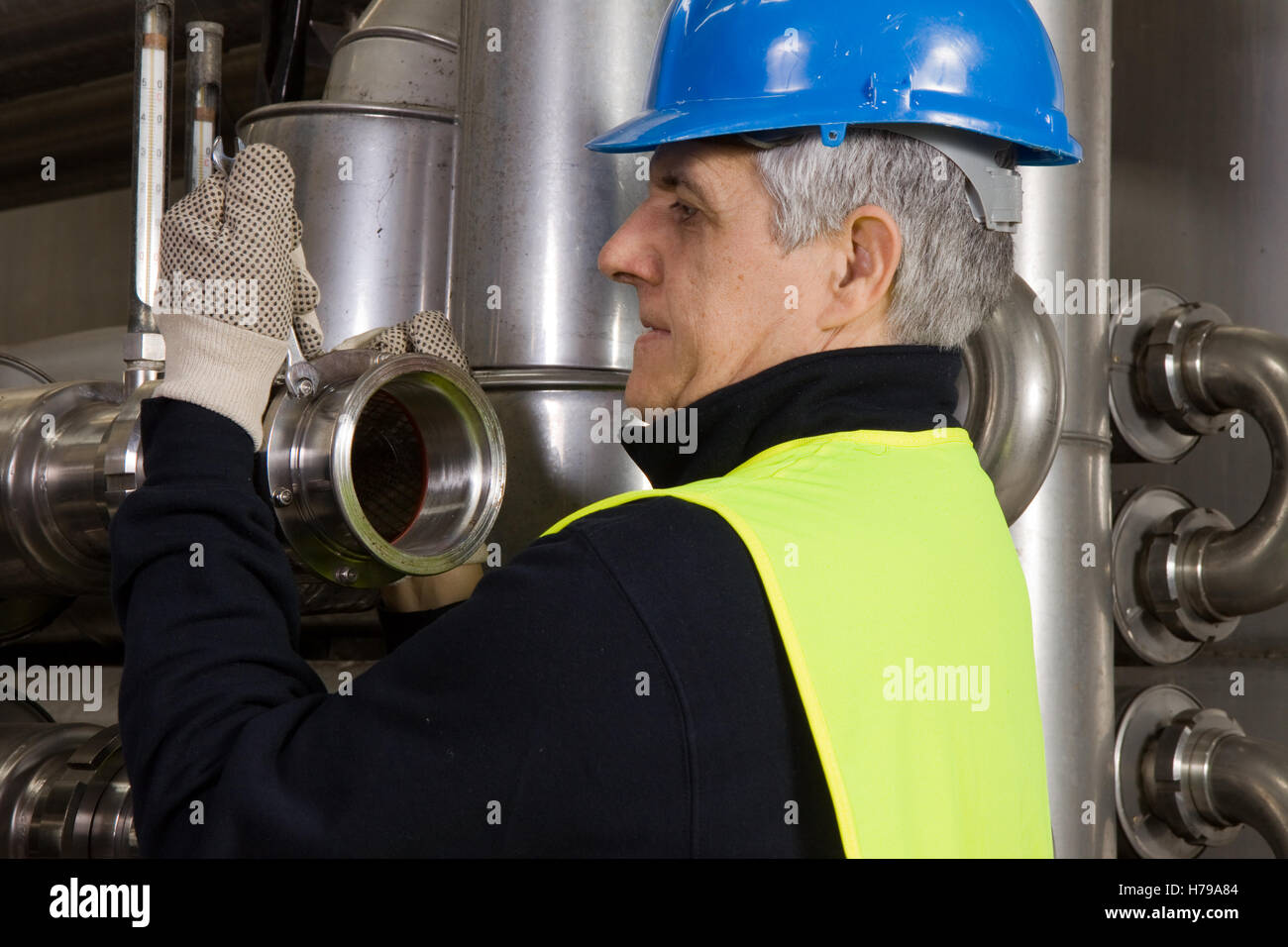skilled worker fitting a pump in a industrial company Stock Photo - Alamy