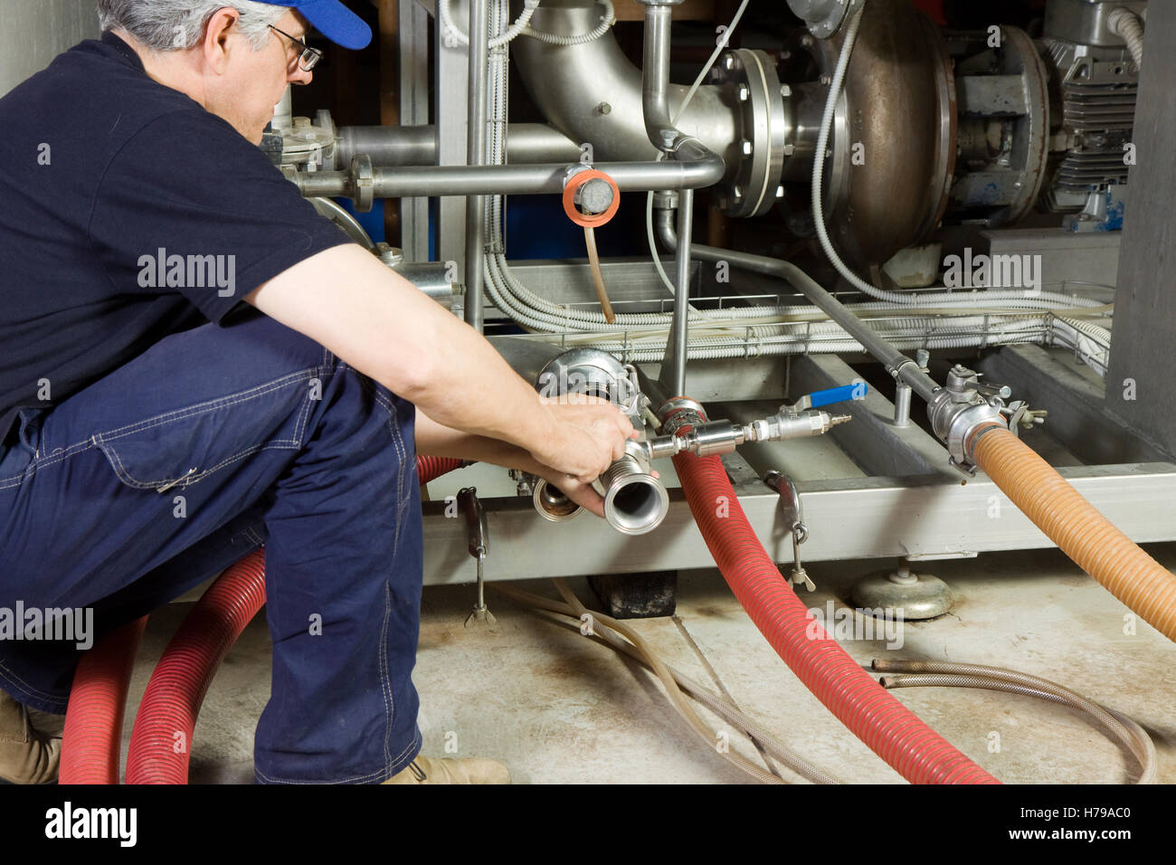 skilled worker fitting a pump plant in a industrial company Stock Photo ...