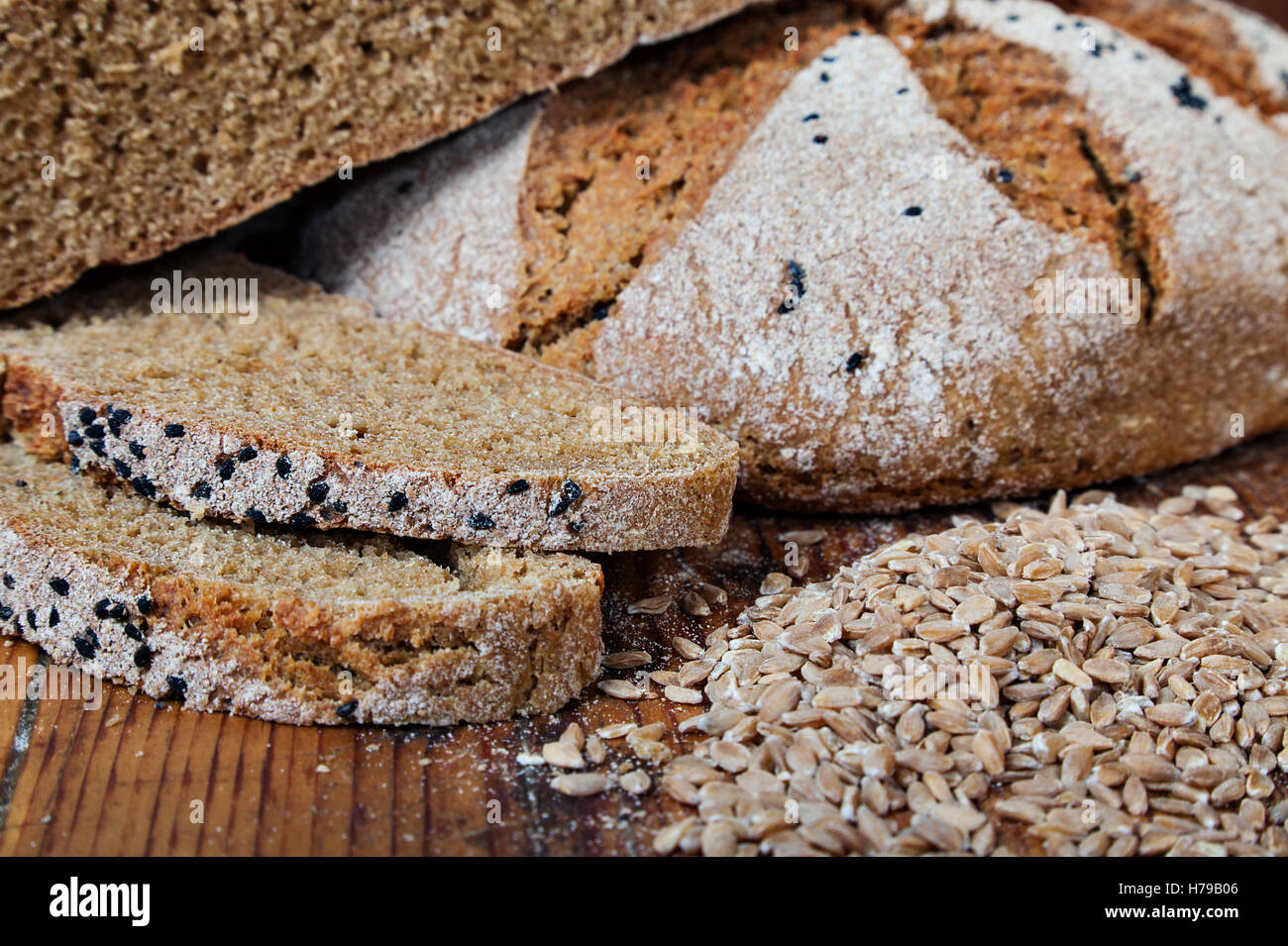 Horizontal image of couple slices of full grain bread with some pile of ...