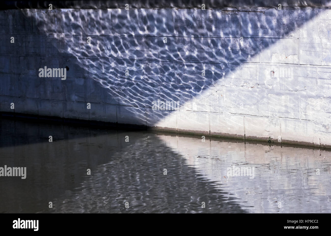 Original geometric reflection of sun in water Stock Photo - Alamy