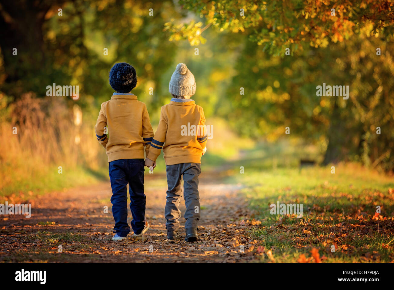 Two children walking hi-res stock photography and images - Alamy
