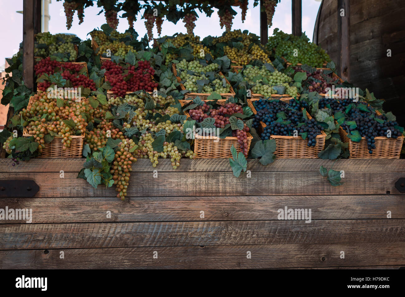 Bunch of Colorful Grapes in Wicker Basket on Wooden Shelf For Sale ...