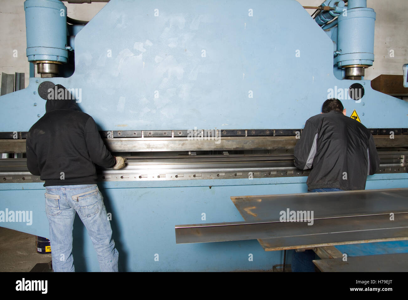 metalworker cutting iron sheets with a machine Stock Photo - Alamy