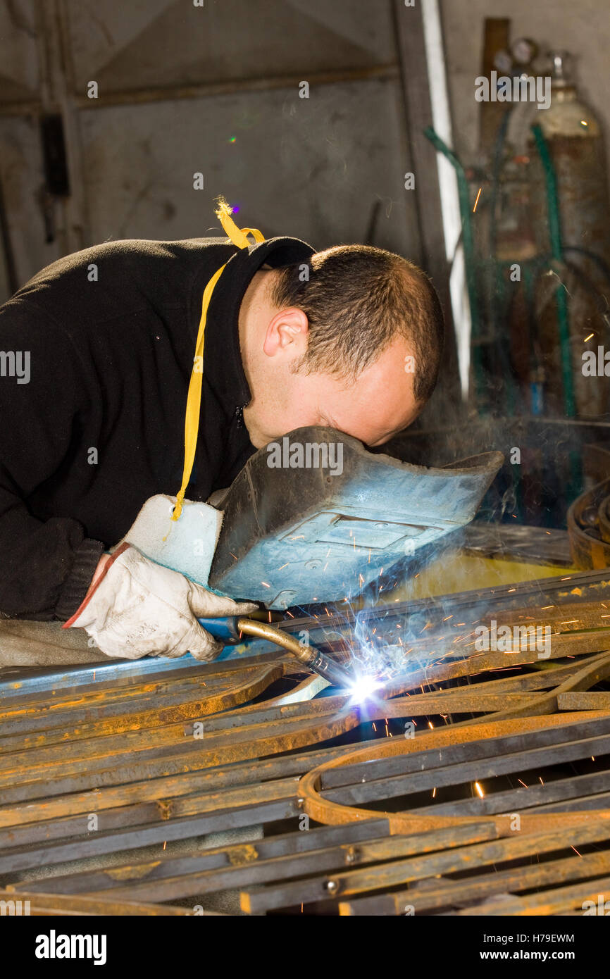 metalworker welding in his workshop Stock Photo - Alamy
