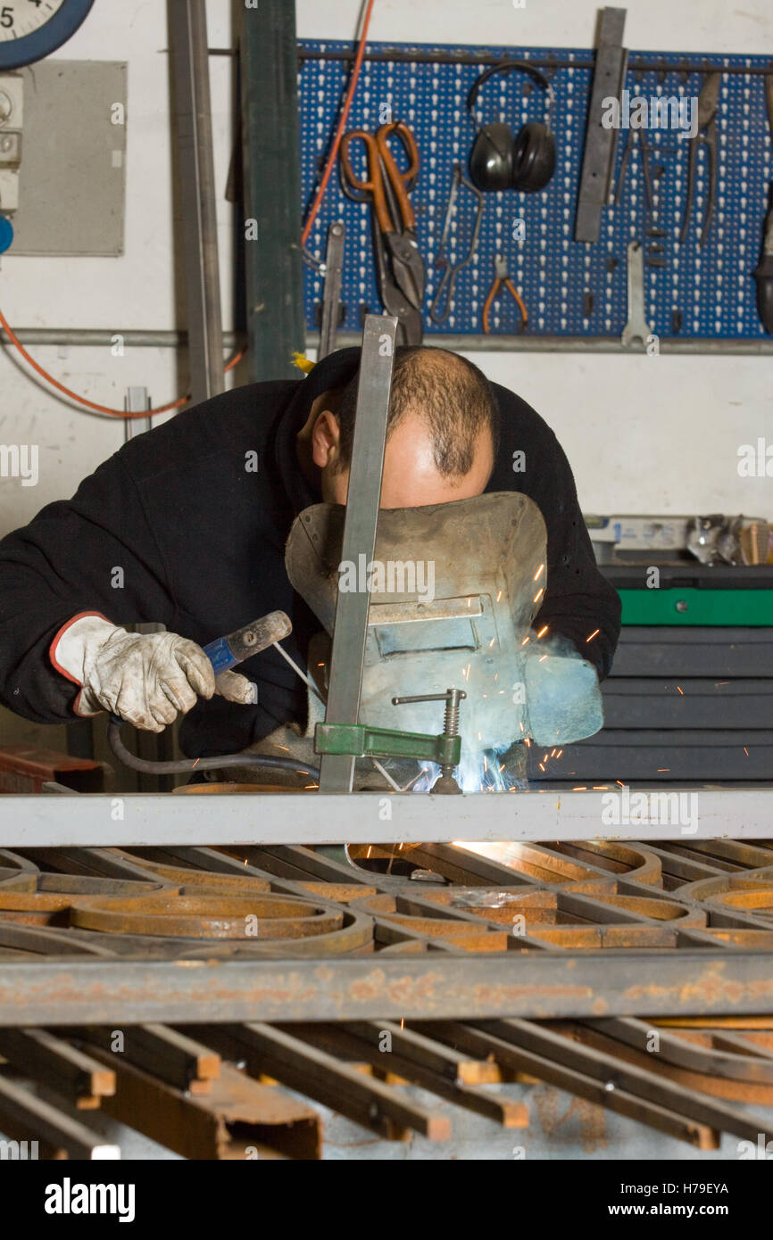 metalworker welding in his workshop Stock Photo - Alamy