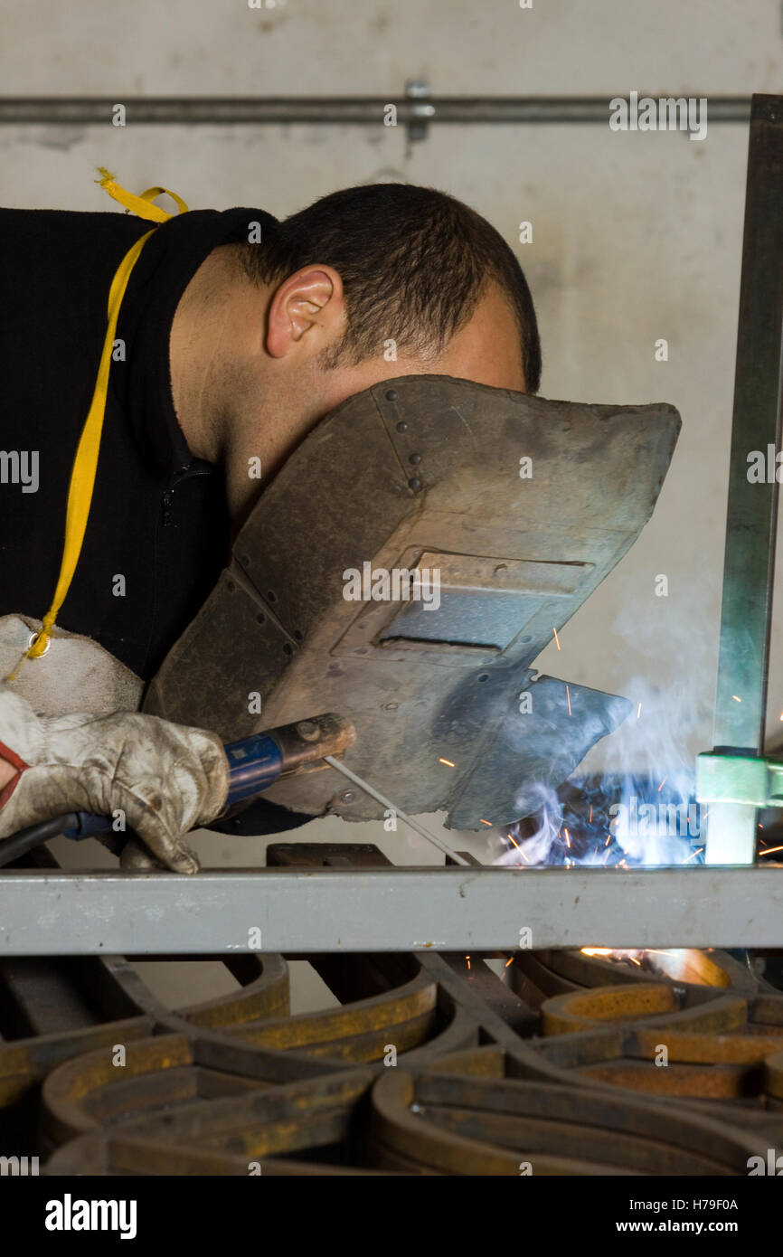 metalworker welding in his workshop Stock Photo - Alamy