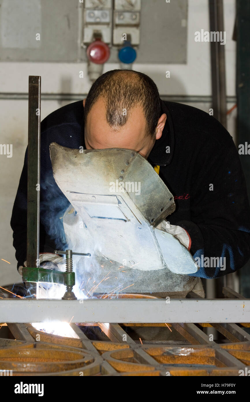 metalworker welding in his workshop Stock Photo - Alamy