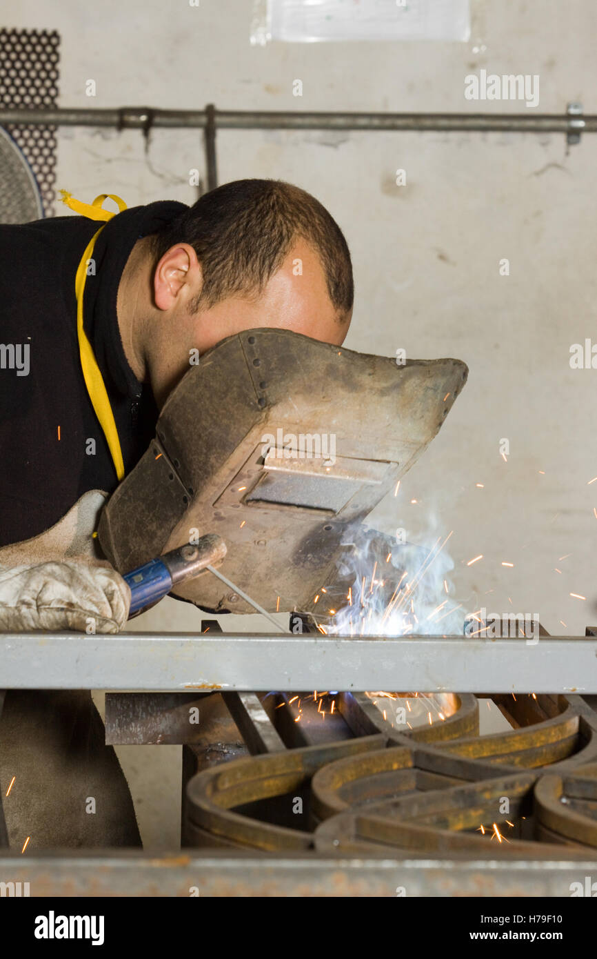 metalworker welding in his workshop Stock Photo - Alamy