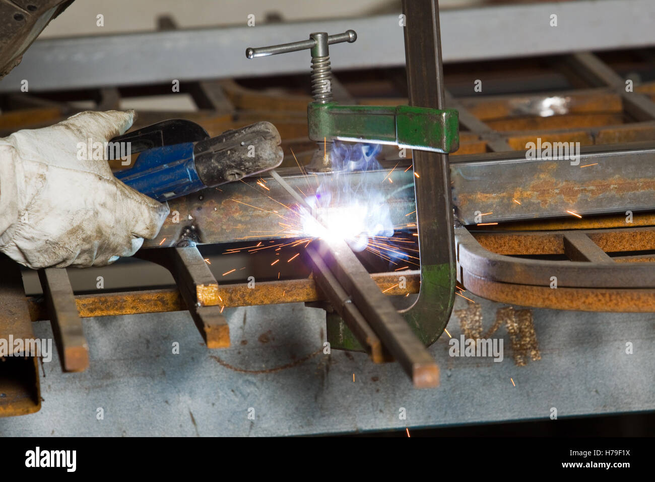 metalworker welding in his workshop Stock Photo - Alamy