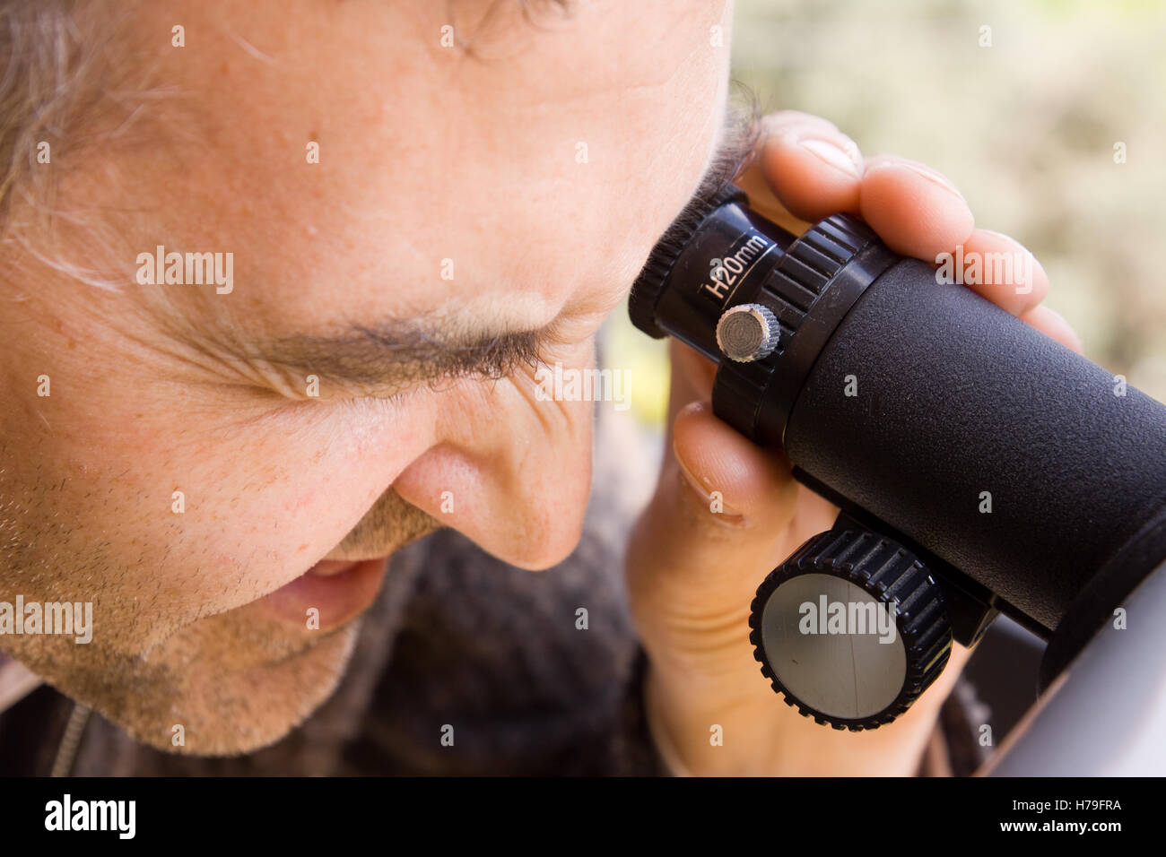watching through the lens Stock Photo - Alamy